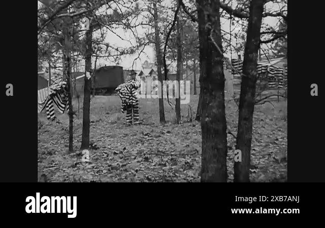 1938 - A prisoner on a chain gang puts out striped uniforms to dry on a ...