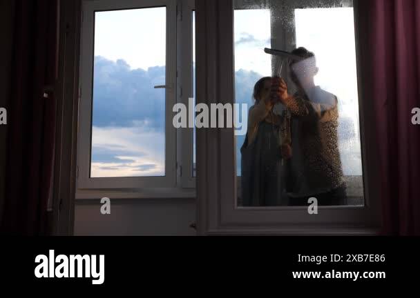 father and his little daughter do household chores. little girl helps ...