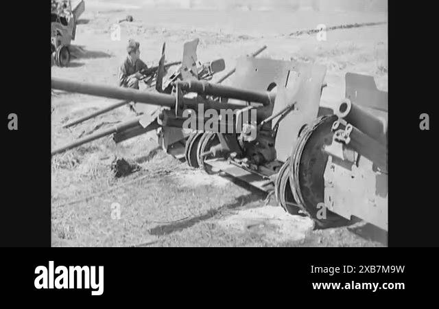 1951 - An American soldier takes cover behind enemy guns in Wonju ...