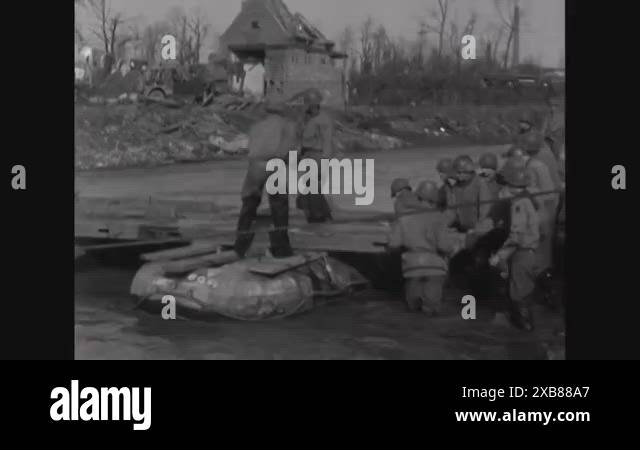 1945 - US Army engineers connect an infantry assault bridge to the ...