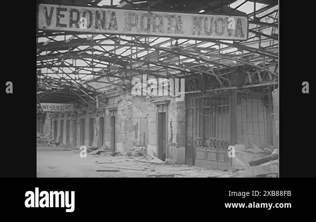 1945 - American soldiers drive through the wreckage of a train station ...