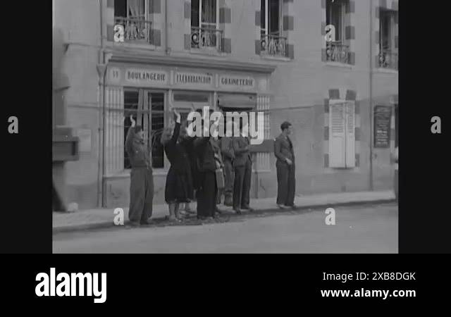 1944 - In La Haye-du-Puits a few French civilians wave and cheer when ...