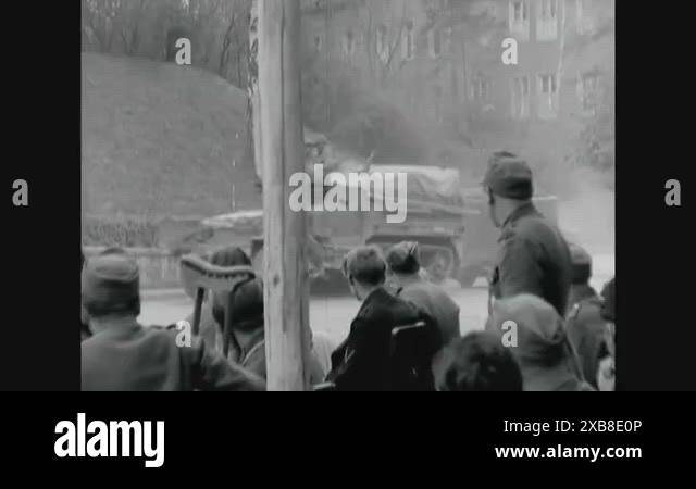 1945 - US Army armored vehicles drive by a Red Cross building in ...