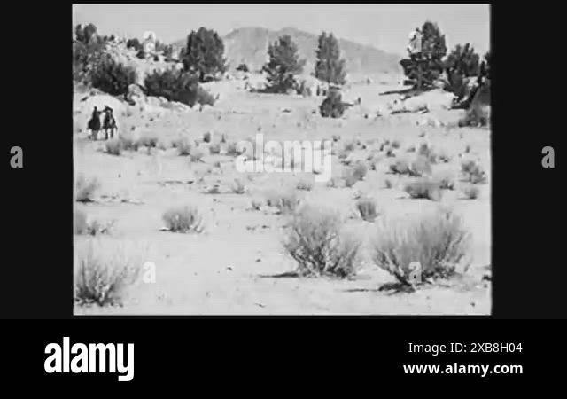 1932 - In this western, two men are fighting each other while riding ...