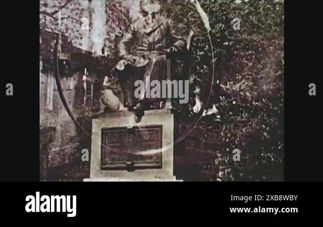 Shots of a statue of Hazen S Pingree, and cars travel down a downtown a ...