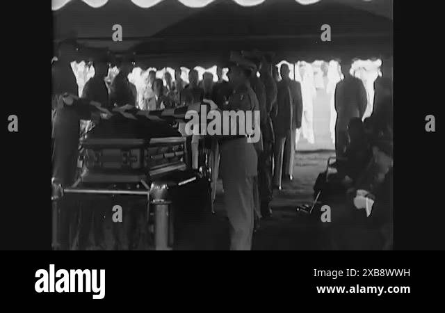 1951 - Mourners attend a funeral service inside a tent at Arlington ...