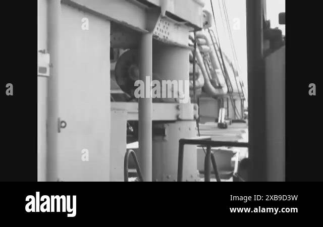 1945 - Aboard a warship gun crew from various parts of the ship are ...