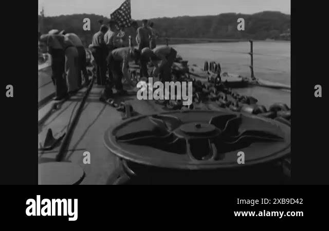 1945 - The anchor of a naval warship is being raised with focus on the ...
