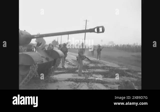 1950 - Marines are walking past a tank knocked out by mortar fire and ...