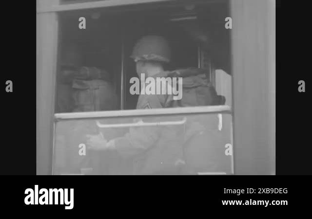 1951 - Soldiers are walking inside a train and looking through the ...