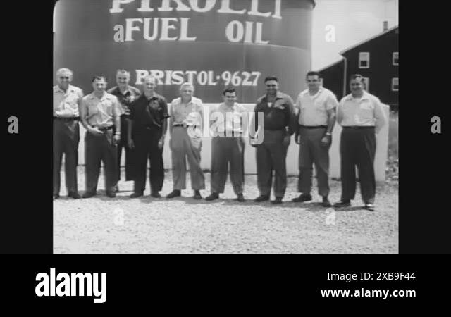 Pirolli Fuel Oil employees pose in front of a tank and a fleet of ...