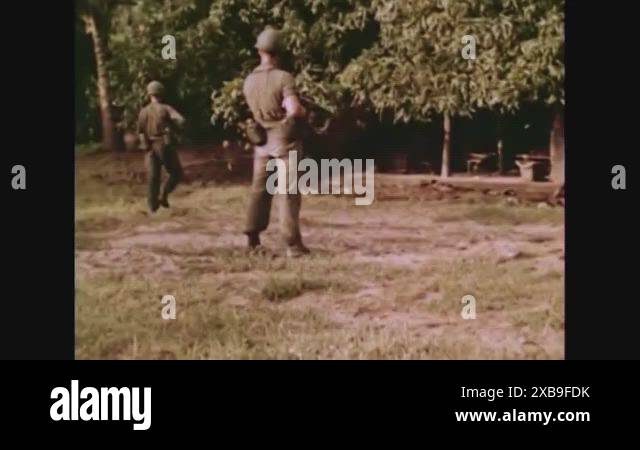 1974 - Soldiers search a village and interact with the villagers in a ...