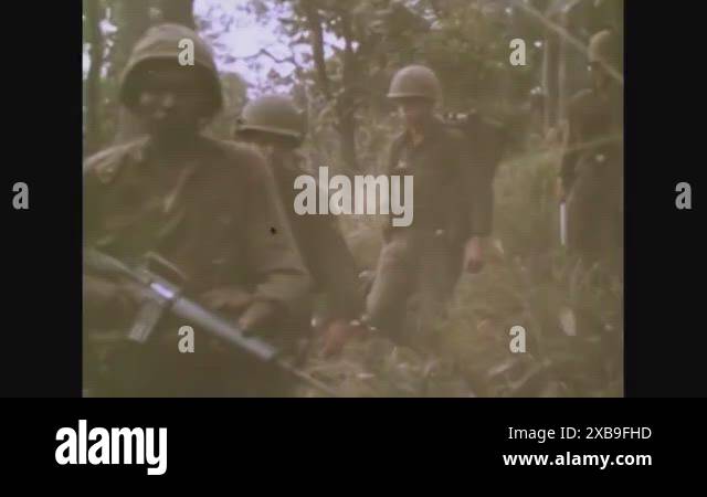 1974 - Soldiers search a jungle and various captured weapons are shown ...