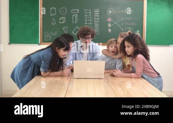 Teacher and multicultural student looking at laptop while celebrate success project and put ...