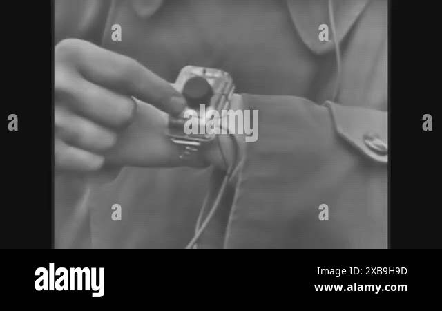 A soldier uses a wrist radio while filming an ambulance for an Army ...