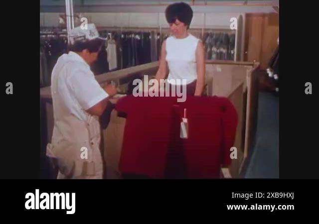 A cashier checks a check against a list of bad check writers and ...