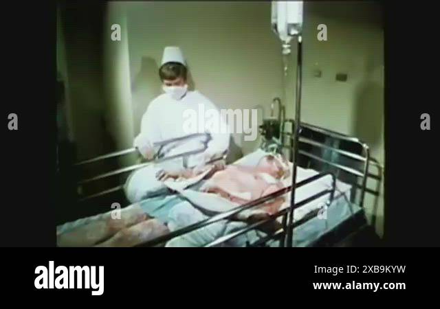 A nurse treats a patient with burns on his hand and his body at a ...