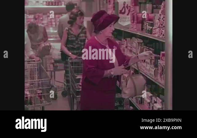 Shoppers in a hectic grocery store include a classy woman with her ...