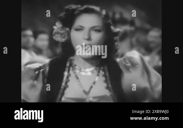 A woman dances and sings a rhumba rhythm in a nightclub in this exotic ...