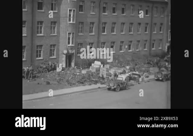 1944 - American soldiers inspect the wreckage of German barracks, and ...