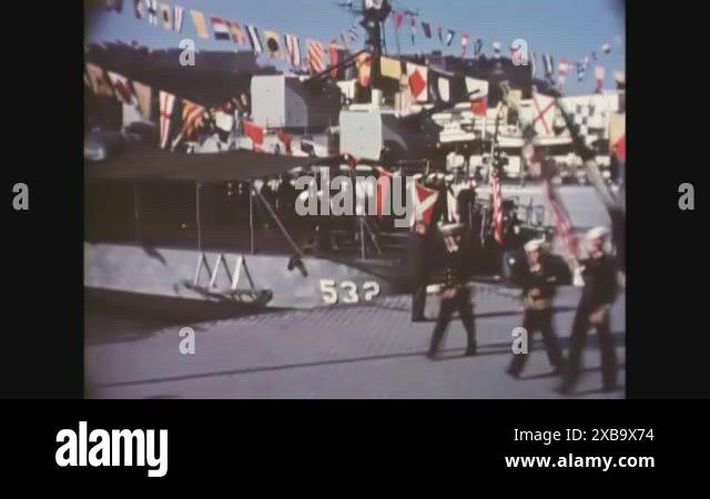 1956 - The US Navy and Marine Honor Guard march on the dock of the USS ...