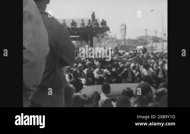 A crowd gathers to observe Black Panther organizer and activist George ...