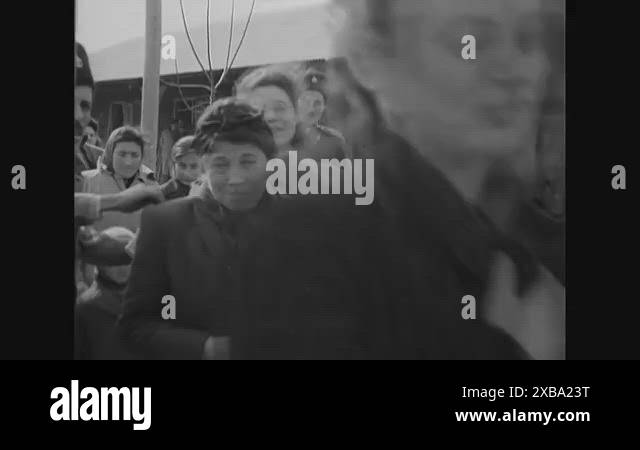 1945 - A group of women and a group of men pass through a checkpoint at ...