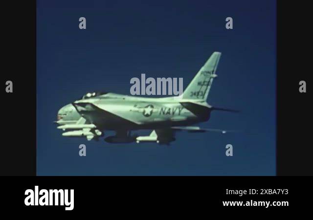 1957 - An FJ-4 plane is in flight with Bullpup missiles under its port ...