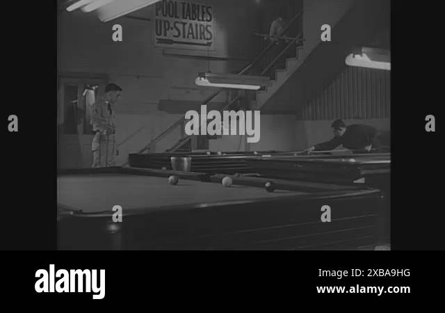 AWOL soldiers dressed as civilians play pool in a bar in the 1950s ...