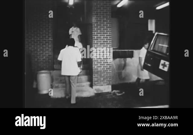 Nurses put a dead body in an ambulance in the 1960s Stock Video Footage ...