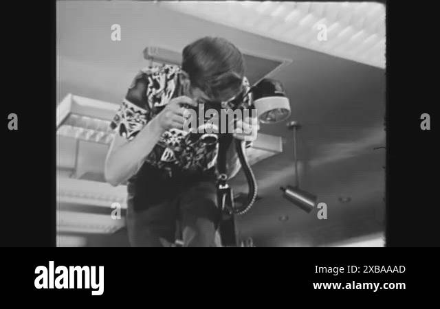 A photographer takes photos of a wound on a dead body at the morgue, a ...