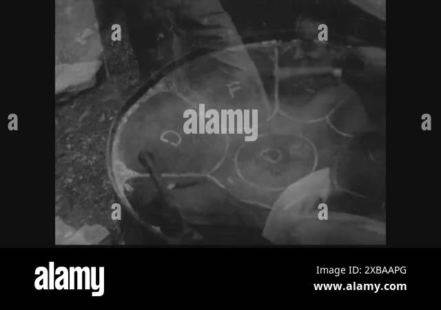 A Trinidadian steel drum band tests their drums for pitch and tune in ...