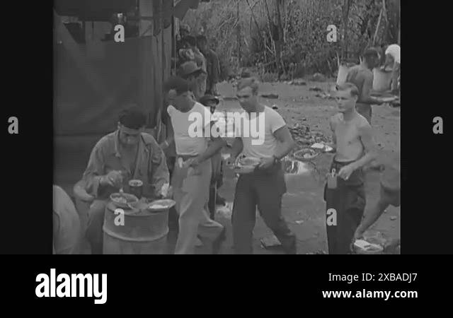 1945 - Soldiers line up with mess kits and get food in Okinawa during ...