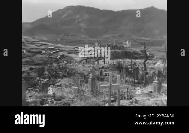 1945 - A Japanese physicist measures damage to tombstones in a Catholic ...
