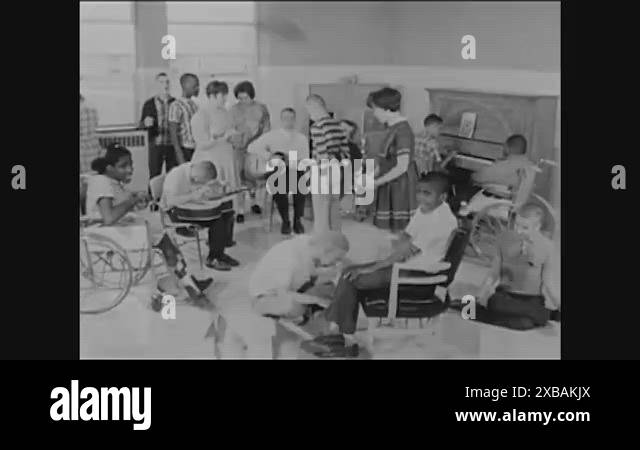 Staff works with severely handicapped children in an infirmary at a ...