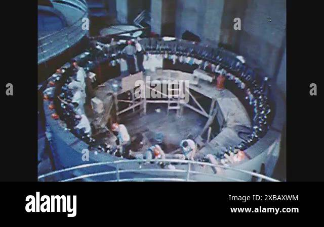 Powerhouse crews prepare a pit and an overhead crane is used to move ...