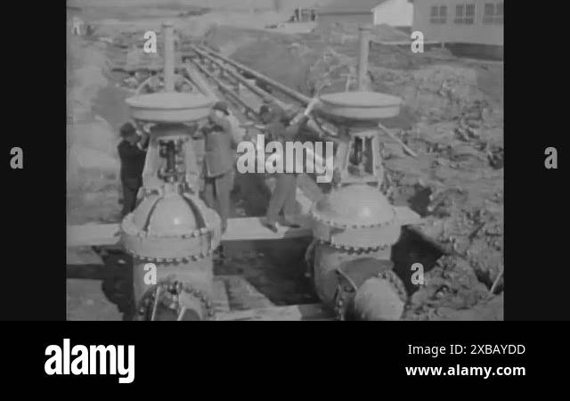 Engineers turn valve wheels, open an oil pipeline and fill a train ...