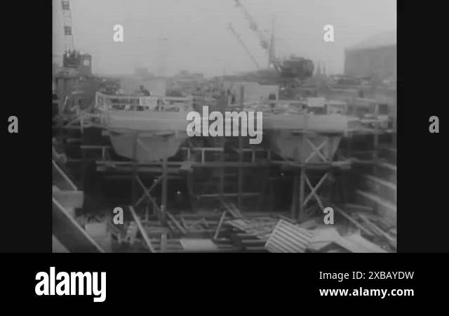 The USS Hopping and a tanker ship are launched from shipyards during ...