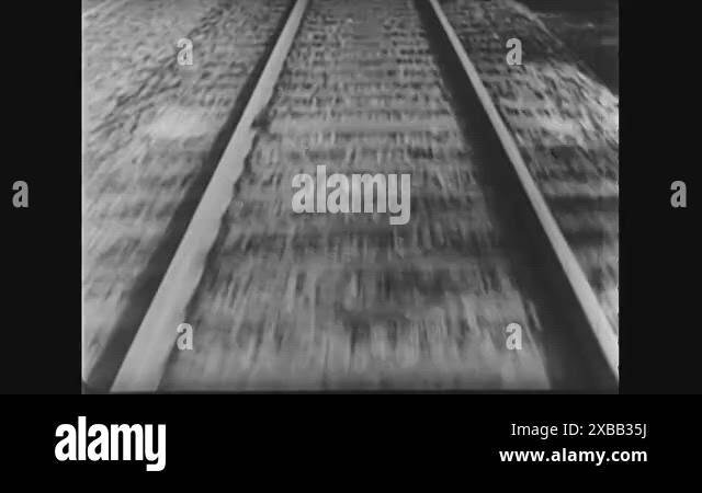 Construction materials are unloaded from a train into waiting trucks in ...