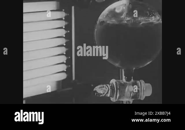 A scientist charts his findings while performing an experiment ...