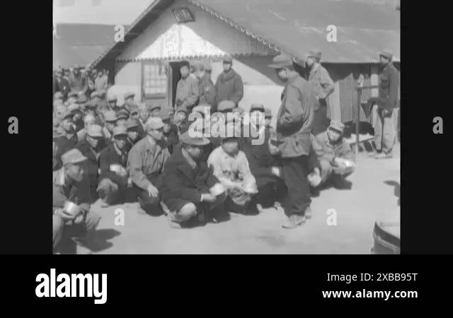 1952 - Korean and Chinese prisoners of war go through the food line and ...
