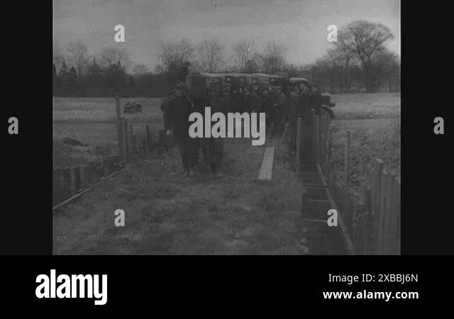 British families mourn their dead as they are buried in a common grave ...
