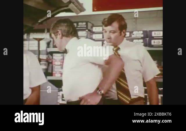 1970 -- A gas station attendant loads a service truck with a variety of ...