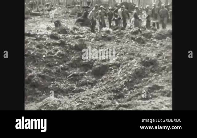 1943 American soldiers bury dead American soldiers after a Japanese air ...