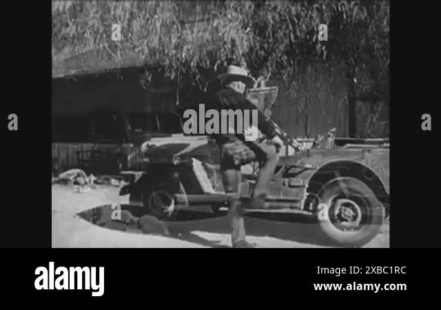 1949 - A cowboy and a boy ride in a jeep on a ranch, and cowboy riding ...