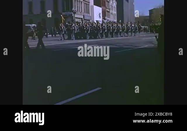A military procession and a horse-drawn caisson carrying a casket ...