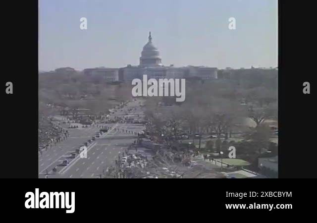A horse-drawn caisson carrying a casket with an American flag is shown ...