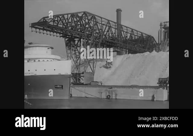 Coal heated and coke is pushed into cars and grab buckets swing from a ...