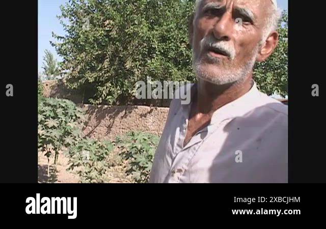 US Soldiers interrogate an old man on the street in the Middle East ...