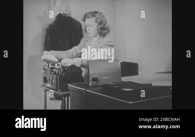 An office worker accidentally knocks over a typewriter and uses a ...